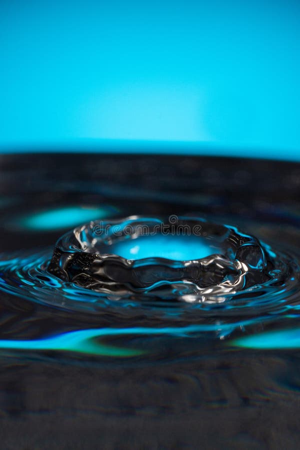 Silver Mercury Crater on Blue Water and Blue Background Stock Image ...