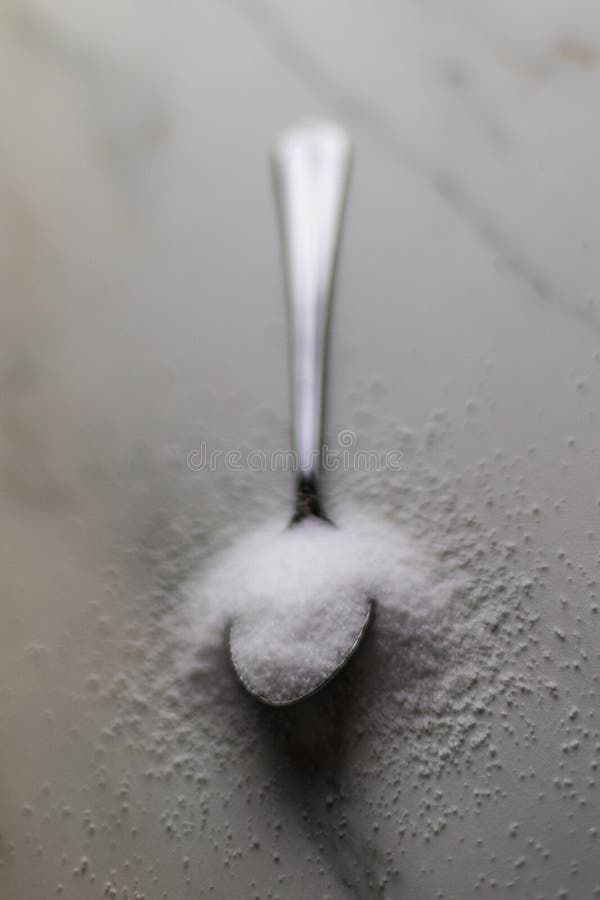 A Silver Metal Spoon with Too Much Salt in it on a Marble Table Stock ...
