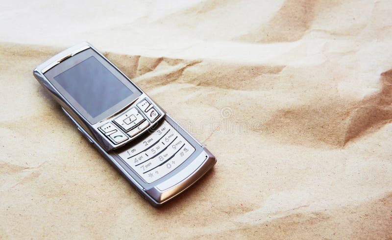 Silver Mobile Phone Slider on Old Paper Background Stock Image - Image ...
