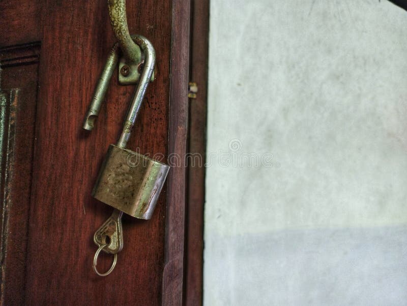 Silver Padlock Key Hanging from Doorknob Stock Image - Image of ...