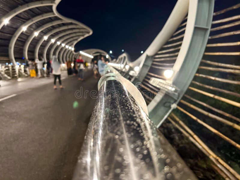 A Silver Pipe Handrail on the Side of the Bridge that Was Wet after the ...