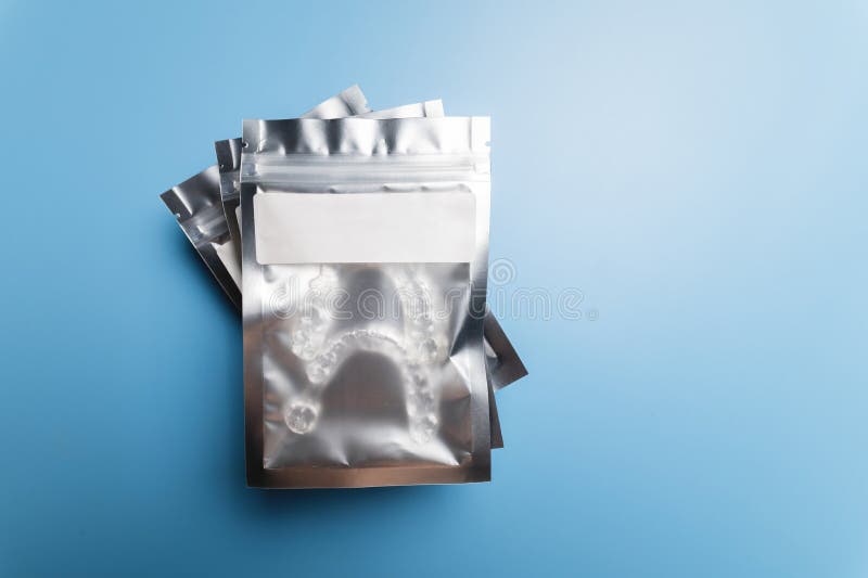 Silver Plastic Package Body with Transparent Braces Inside on a Blue ...