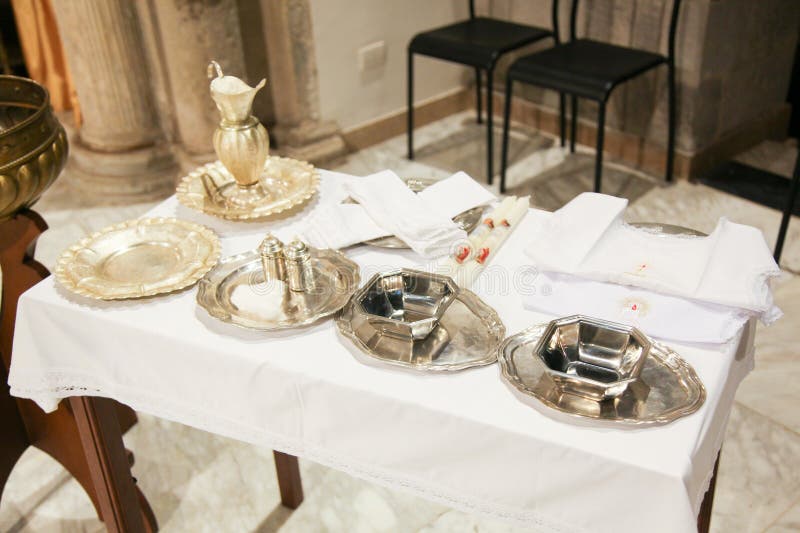 Silver Plates and Religious Items are Lying on a Table with a White ...