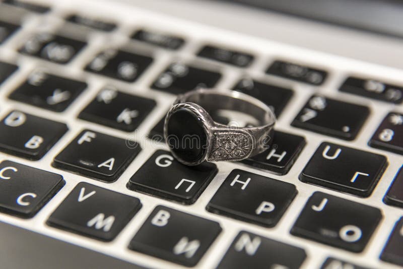 Silver ring & Laptop stock image. Image of alphabet - 105558635
