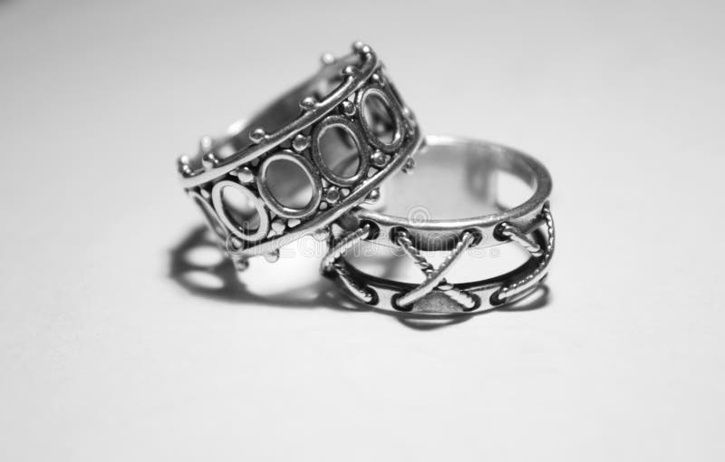 Silver Rings of Different Shapes and a Gold Chain Lie on the Background ...