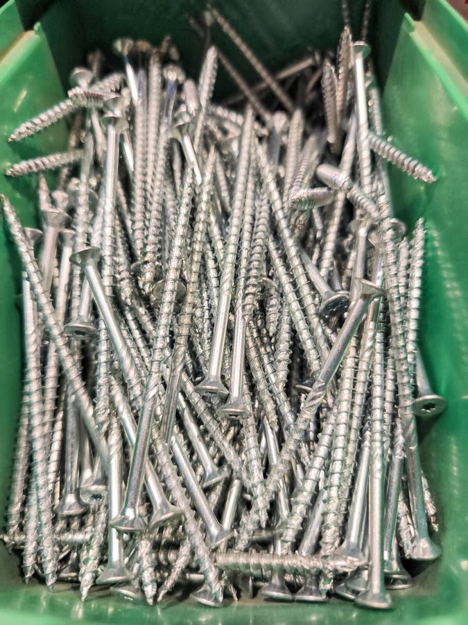 Silver Screws Piled Up in Green Plastic Container for Construction ...