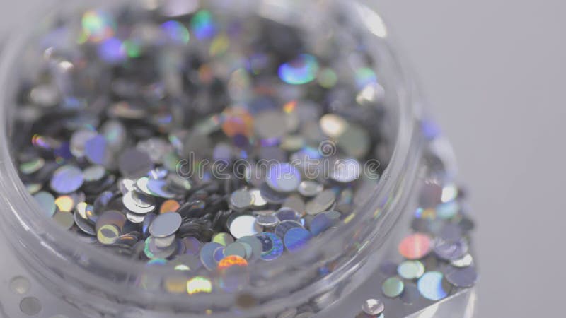 Silver Sequins in a Jar Rotate in a Circle Stock Footage - Video of ...