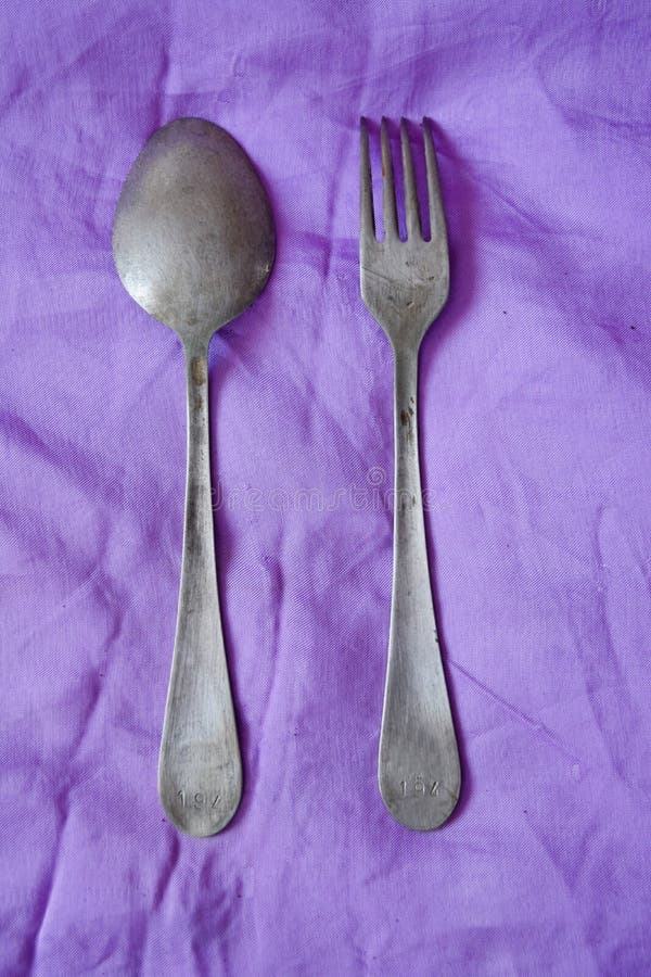 Silver Set Against the Violet Background. Silver Spoon and Fork with an ...