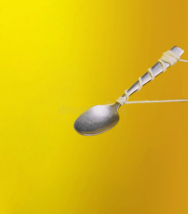 Levitating Spoon on Yellow Background Stock Photo - Image of concept ...