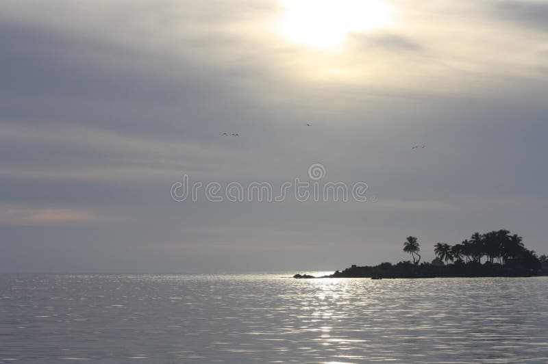 Silver Sunset Above the Sea, Sun Shining through the Clouds. Stock ...