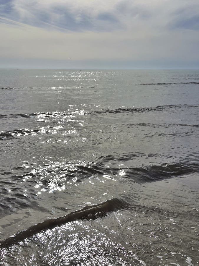 Silver Sunset Above the Sea, Sun Shining through the Clouds. Stock ...