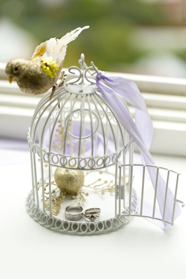 Silver Wedding Rings and Engagement Ring in Decorative Cage of Bird ...
