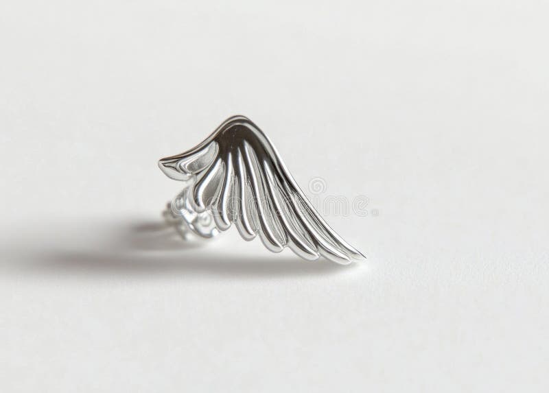 Silver Wing-shaped Ring with Elegant Curved Design on White Background ...