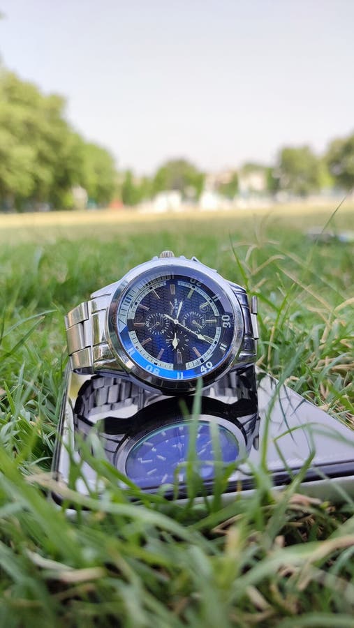 Silver Wrist Clock on a Phone in the Grasses Editorial Stock Image ...