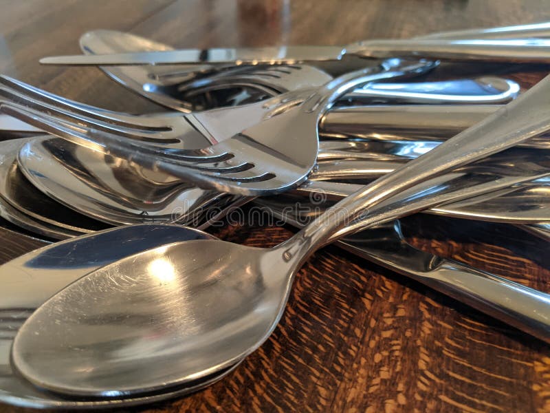 Silverware on wood table stock photo. Image of cutlery - 203817472