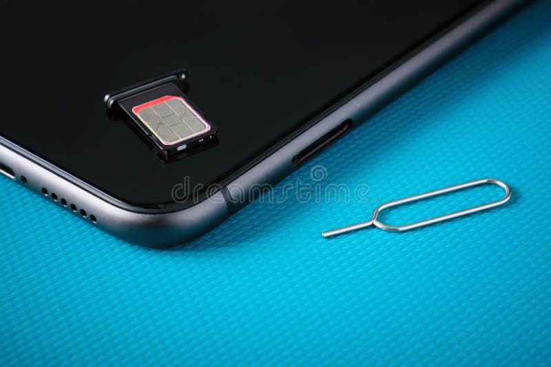 Sim Card Lying on a Dark Smartphone. Replacing SIM Cards for a ...