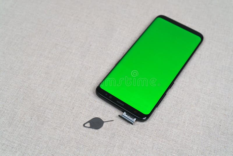 Sim Card Tray and Smartphone with Green Screen and Eject Tool Stock ...