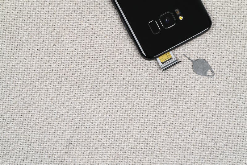 Sim Ejector Tool and SIM Card Slot of Mobile Phone. Top View Stock ...