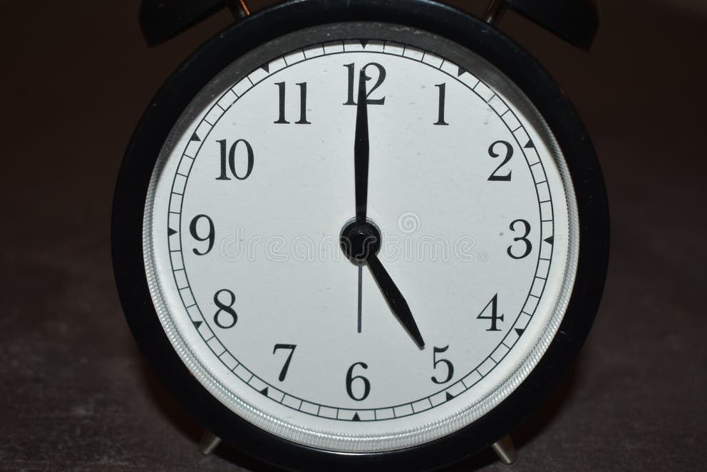 Clock Pointing To Different Times Stock Photo - Image of table, close ...