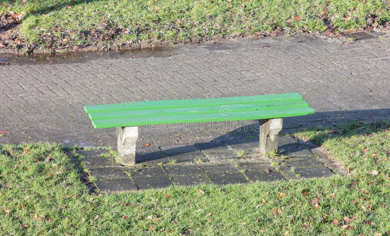 Simple bench in a park stock photo. Image of public - 106377202