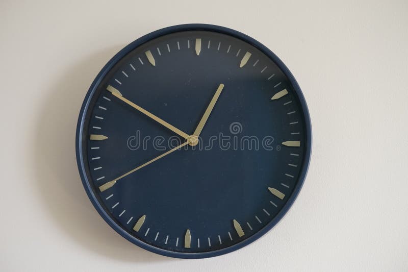 Simple Black Modern Wall Clock Hanging on a Beige Wall. Lunch Time ...