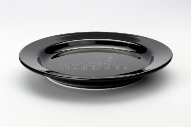 Simple Black Plate on White Table, Versatile for Various Uses Stock ...