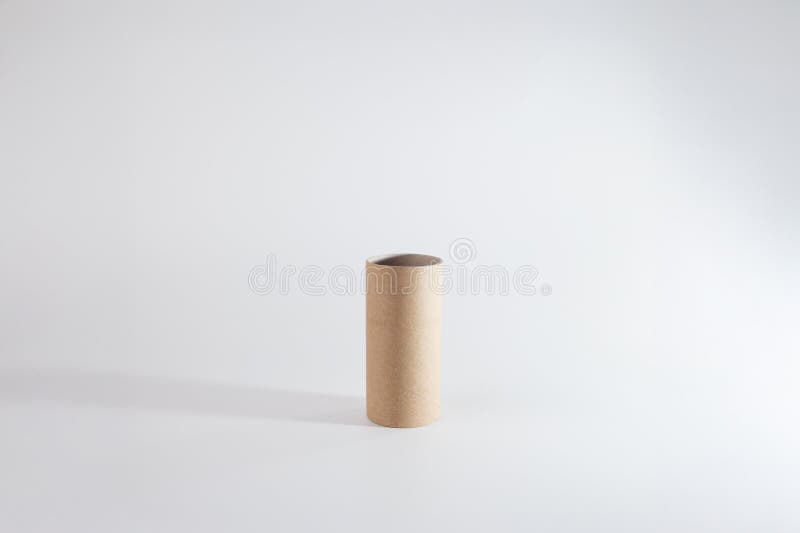 A Simple Cardboard Tube Standing Upright on a Plain Surface. Part of a ...