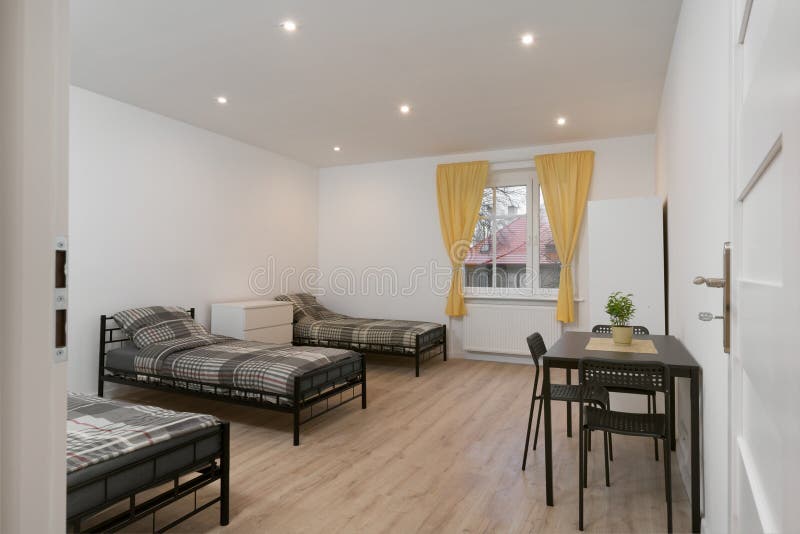 Simple Furnished Dorm Room with Multiple Beds Stock Photo - Image of ...