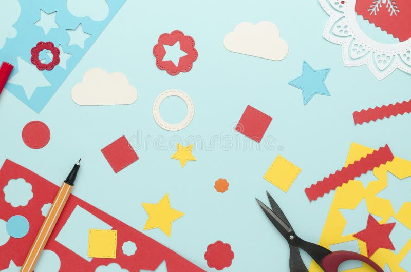 Simple Geometric Shapes Cut from Colored Paper Scattered on a Blue ...