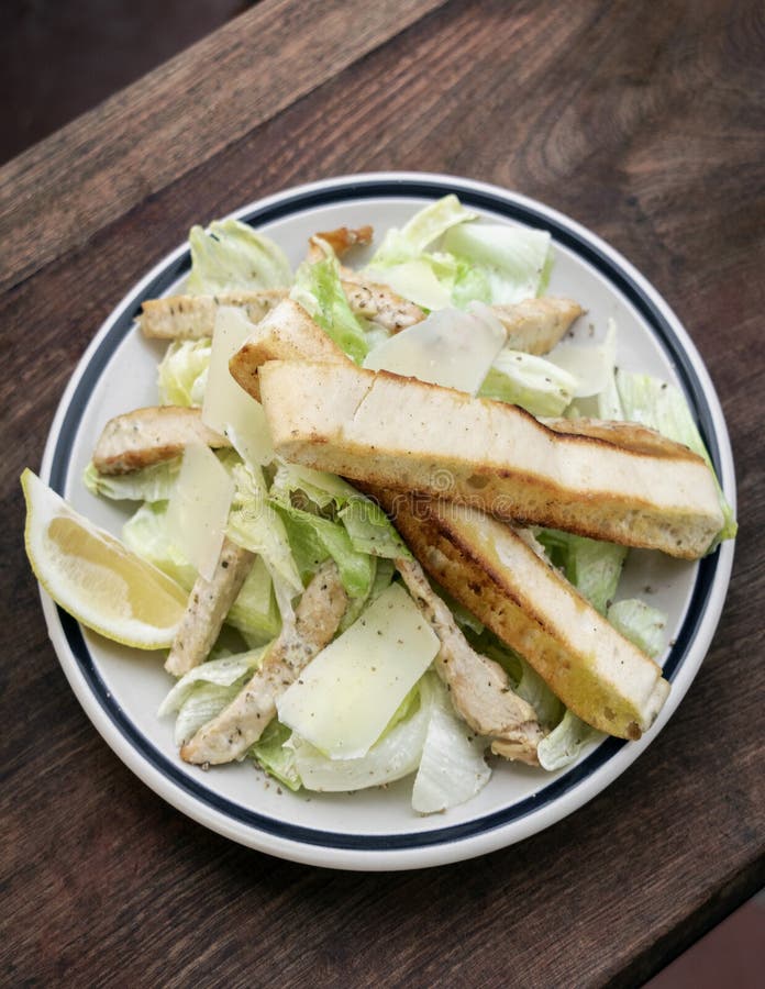 Simple Healthy Chicken Caesar Salad on Wood Table Stock Photo - Image ...