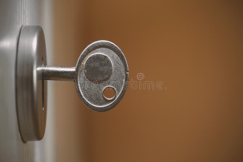 Simple Key in Door Lock stock photo. Image of close - 152323176