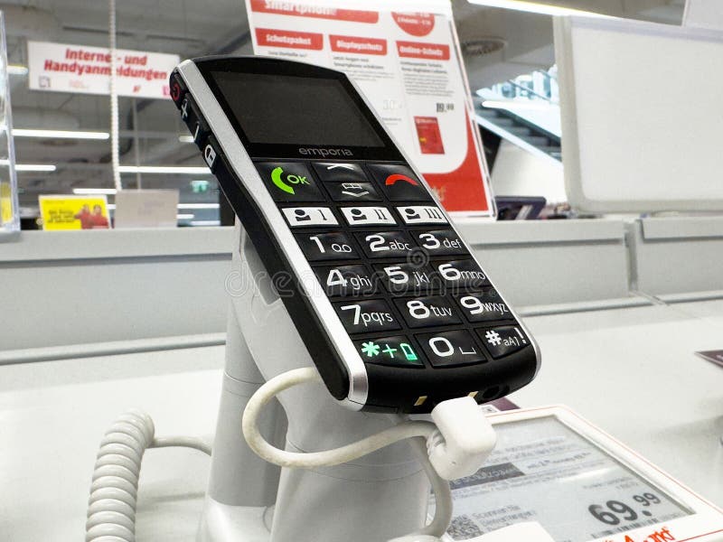 Simple Mobile Phone with Large Buttons on Display Stand in Electronics ...