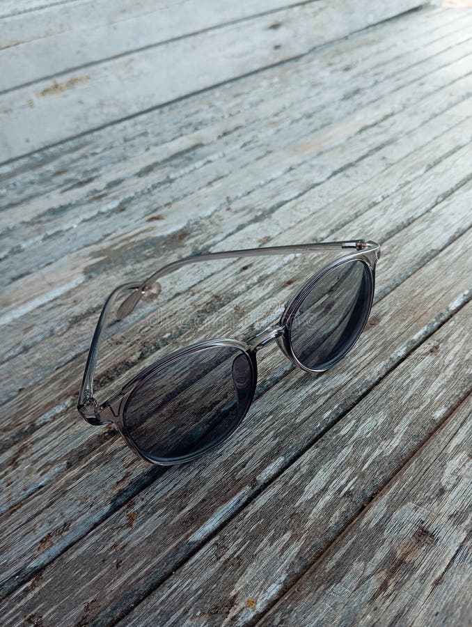 A Simple Pair of Glasses Lay on a Worn Table. Stock Image - Image of ...