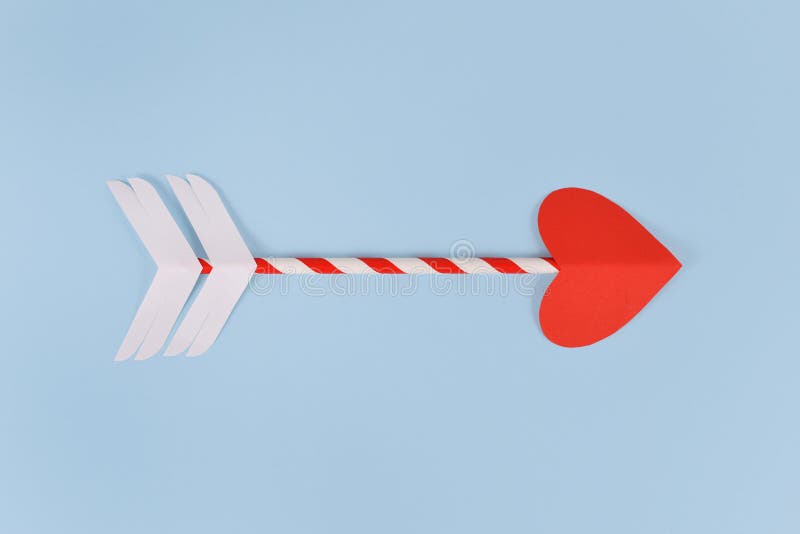 Simple Paper Cupid Love Arrow with Heart Shaped Tip on Blue Background ...