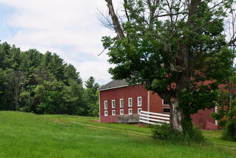 Simple Red Barn with White Windows Under a Mostly Cloudy Sky Stock ...