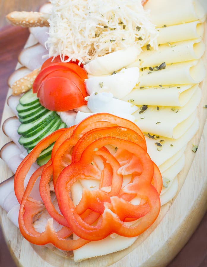 Simple Slicing of Assorted Snacks on a Wooden Plate Stock Photo - Image ...