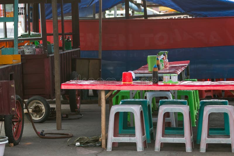 A Simple Street Vendor S Stall with Plastic Chairs and Several Bottles ...