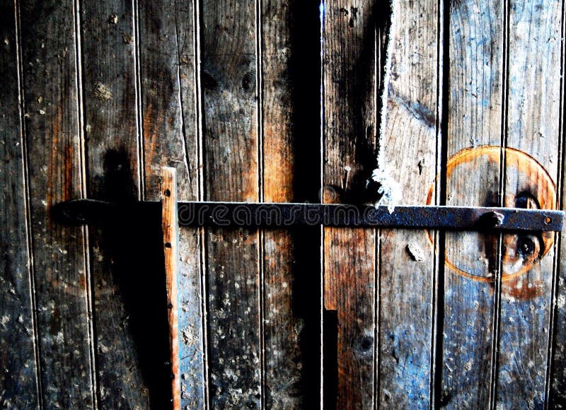 Simple Swinging Iron Bar Lock Inside an Old Barn Door Bathed in Bright ...