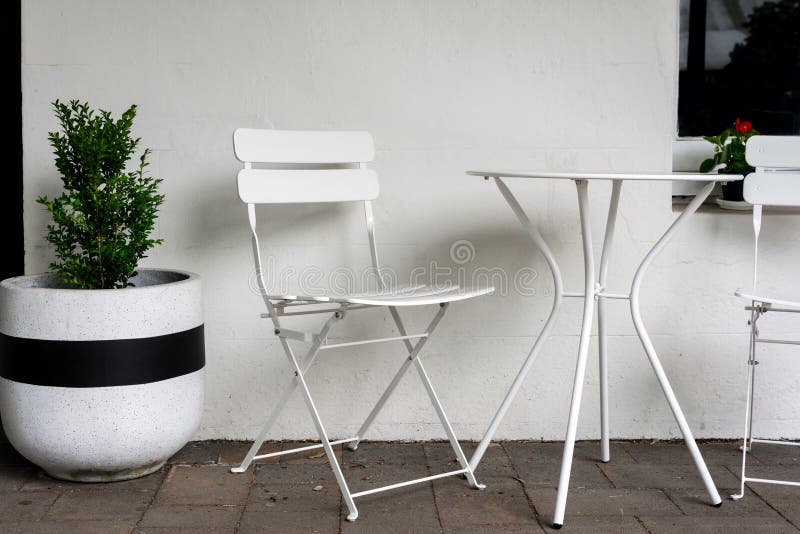 Simple Table and Chairs Against Wall Stock Photo - Image of table ...