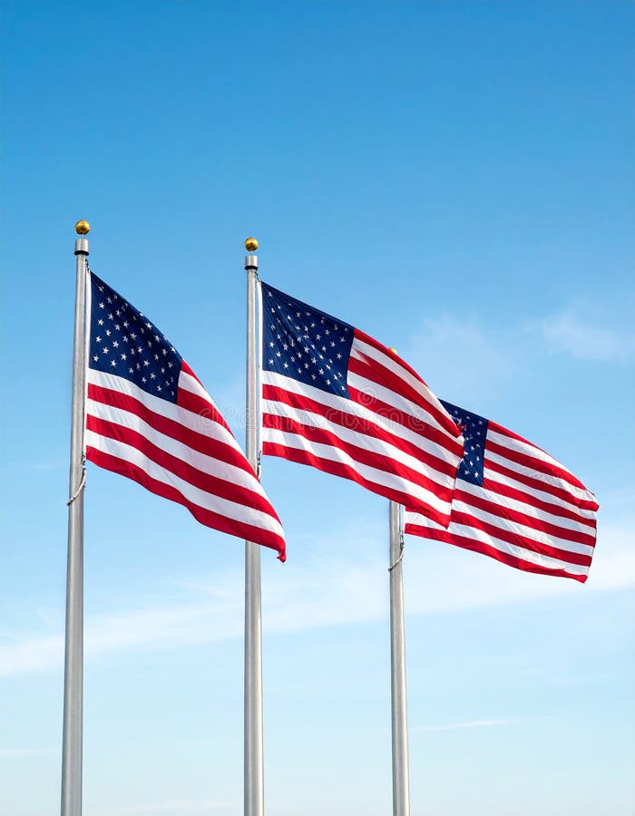 A Simple Trio of Stars and Stripes Flags Blowing in the Wind Against a ...