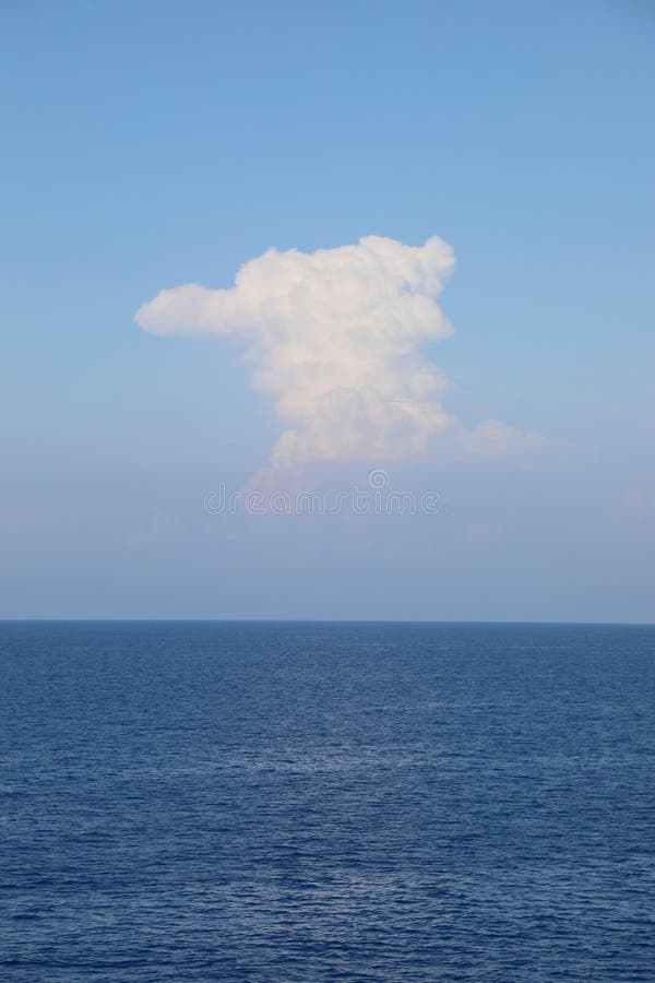 Simple Vertical Background with Blue Sea Below and a Tall White Cloud ...