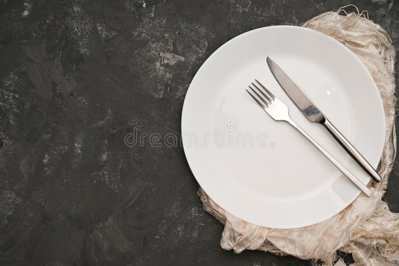 Simple White Ceramic Plate with Silverware and Copy Space on Modern ...