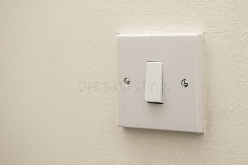 A Simple White Electrical Light Switch on a White Wall. Industrial ...