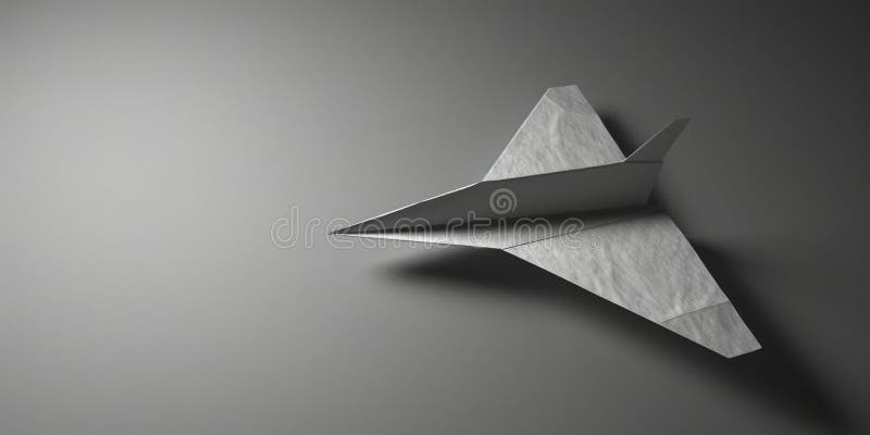 A Simple White Paper Airplane Lies on a Gray Surface, Ready To Take ...