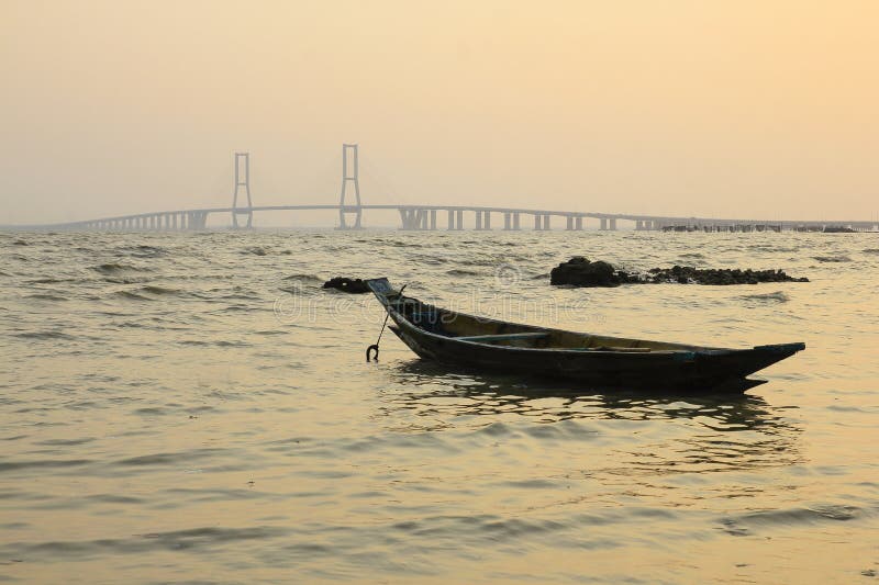 A Simple Wooden Boat Stranded in Waters of the Madura Strait Stock ...