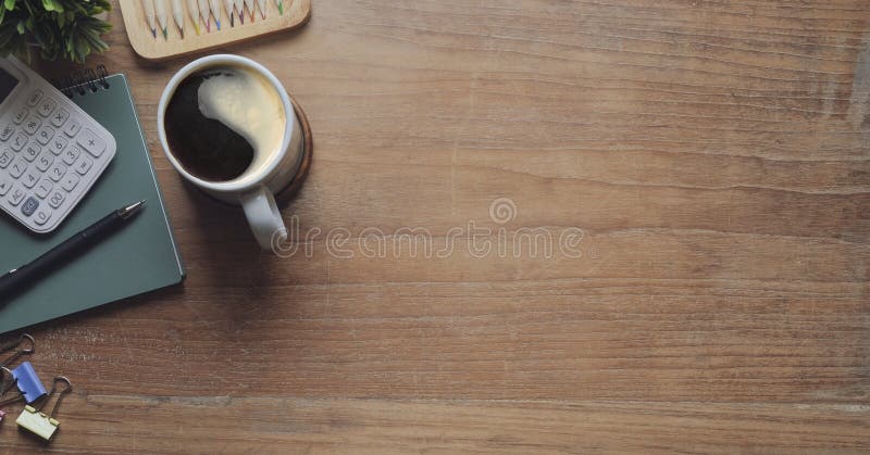 Simple Workplace with Coffee Cup, Calculator and Notebook on Wooden Desk. Top View with Copy ...