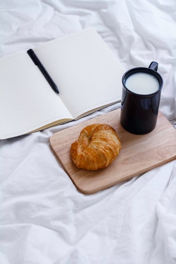 Cup of Hot Milk, Croissant and Book on Working Table in the Morning ...