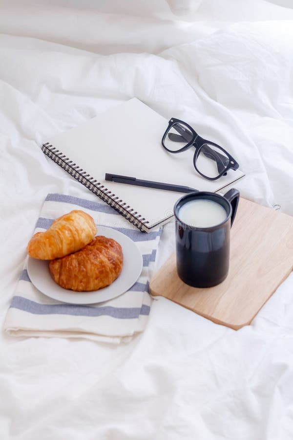 Cup of Hot Milk, Croissant and Book on Working Table in the Morning ...