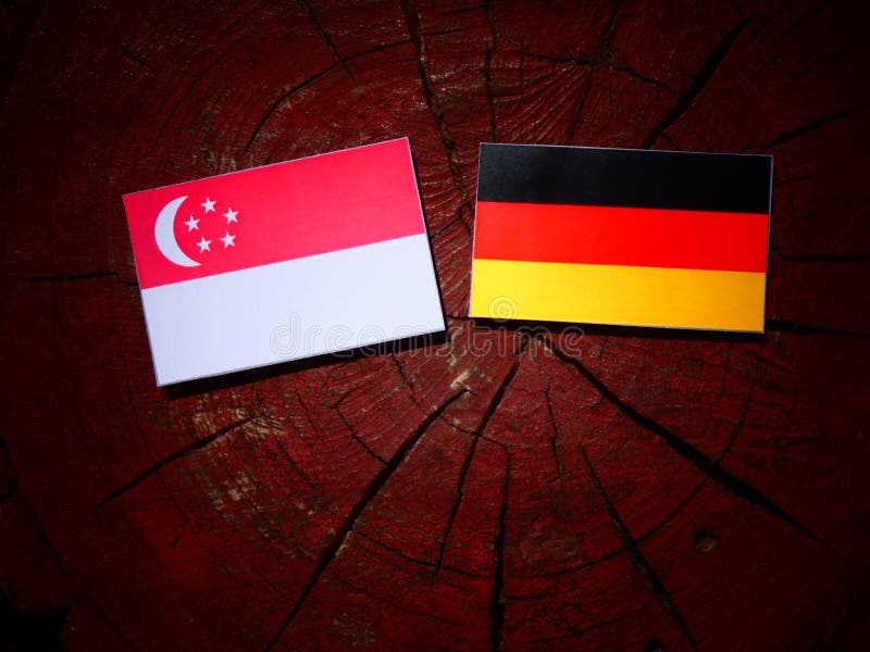 Singaporean Flag with German Flag on a Tree Stump Stock Image - Image ...