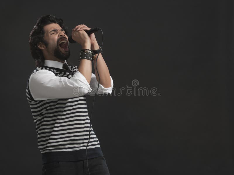 Singer Holding a Mike and Singing Stock Photo - Image of black, open ...
